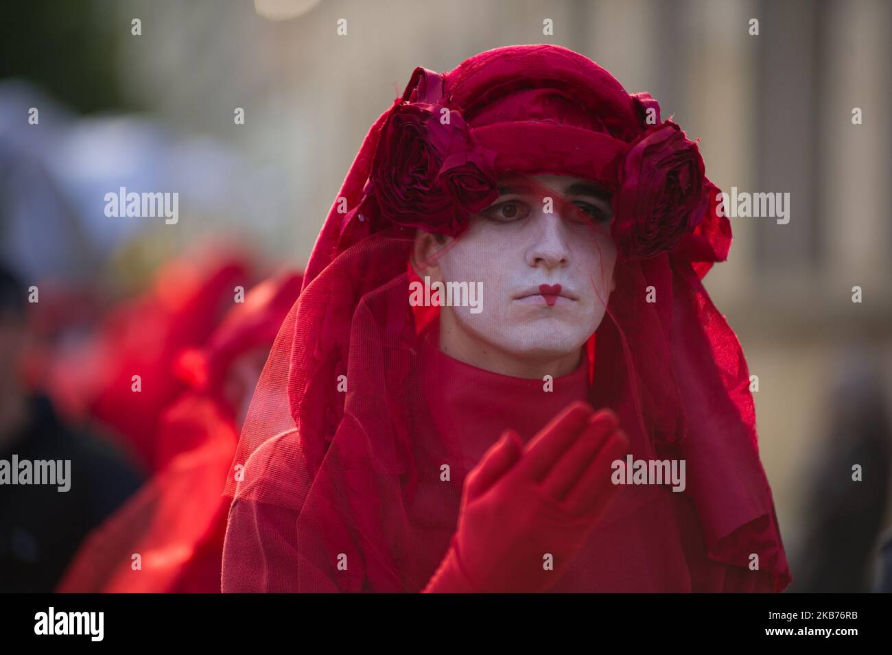 Extinction Rebellion activists are seen performing as Red Rebellion ...