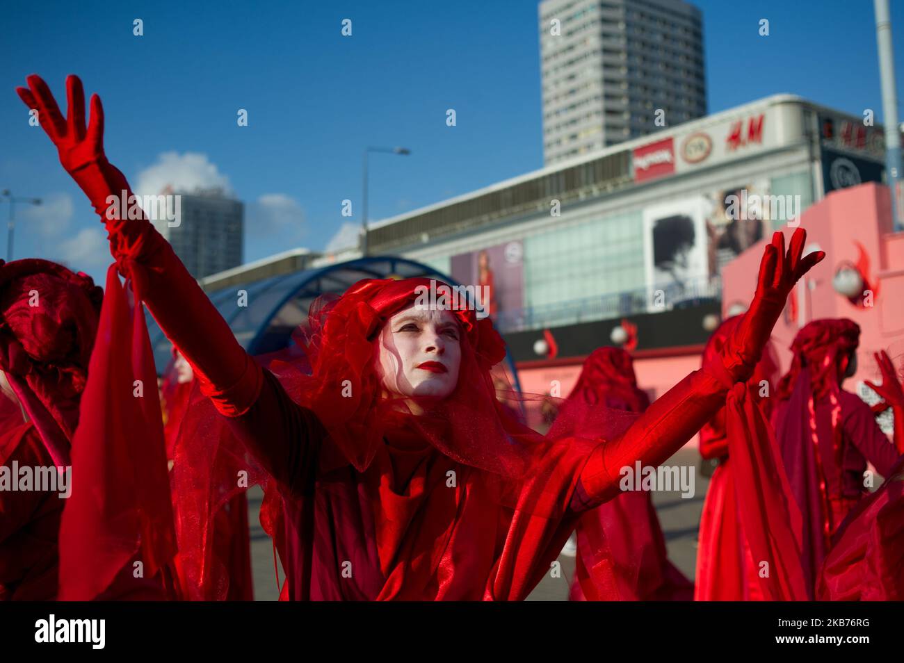 Extinction Rebellion activists are seen performing as Red Rebellion ...