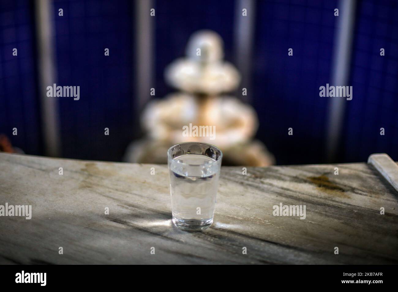 People drink and wash off a fountain of hot sulfur water in the ...