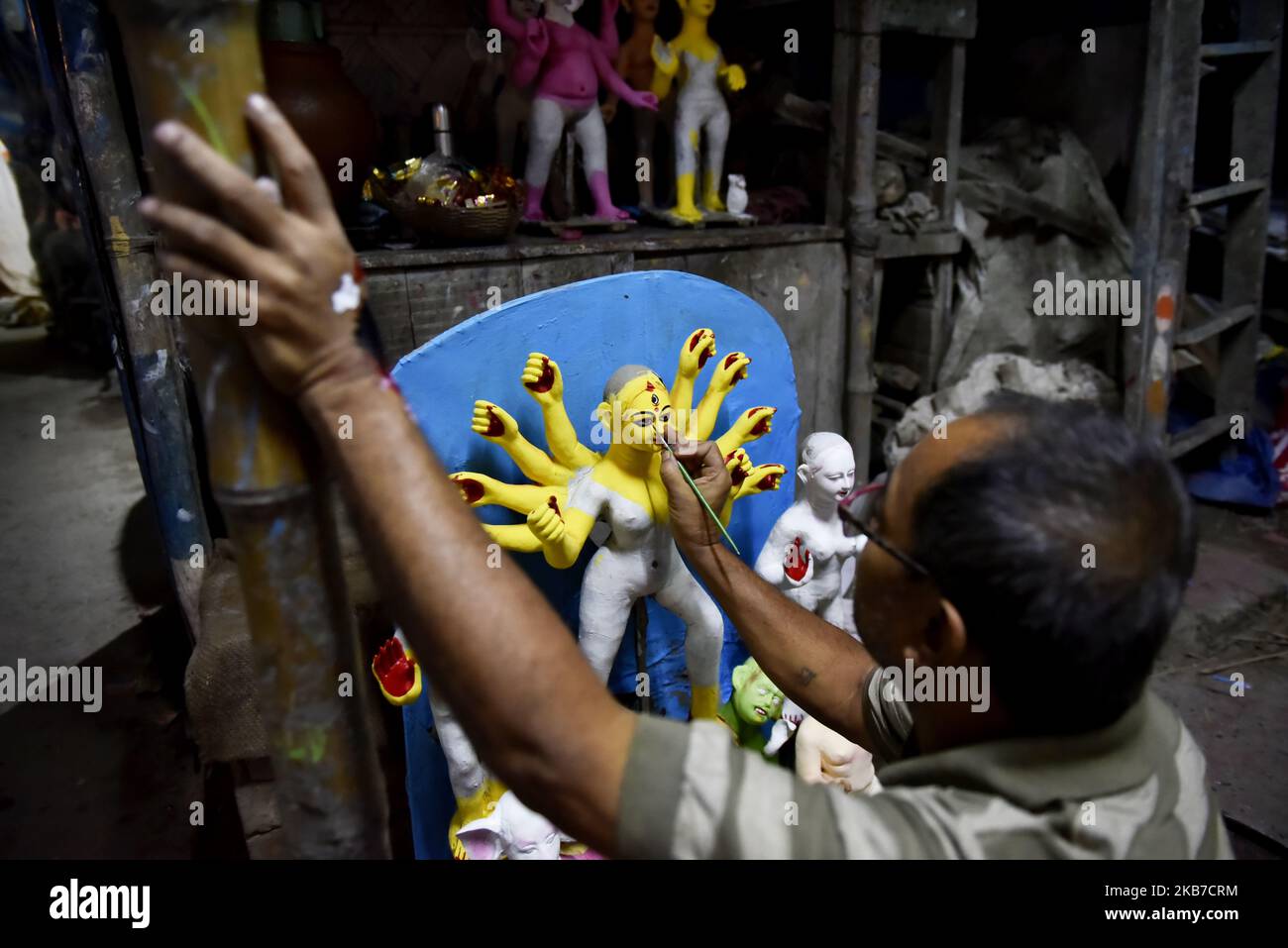 An artisian draws an eye of a Durga Idol (A Hindu Goddess) inside a ...
