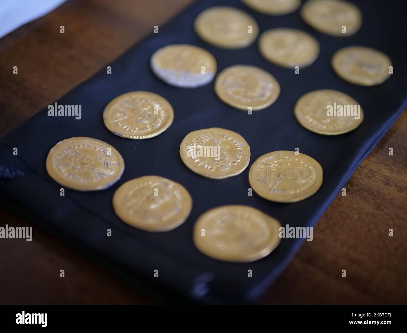 The archaeologist Hristo Kuzov shows golden coins, discovered during ...