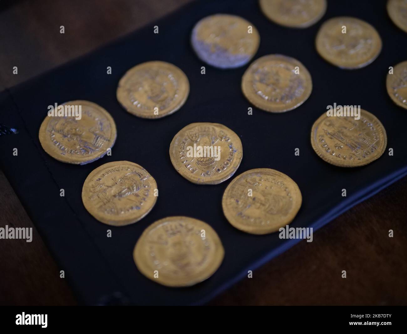 The archaeologist Hristo Kuzov shows golden coins, discovered during ...