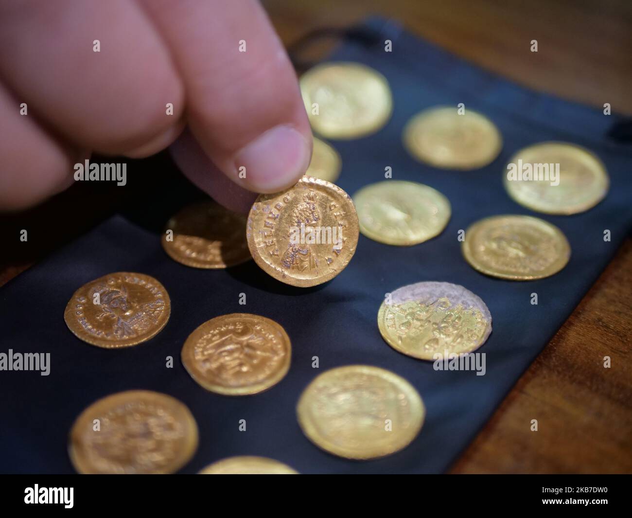 The archaeologist Hristo Kuzov shows golden coins, discovered during ...