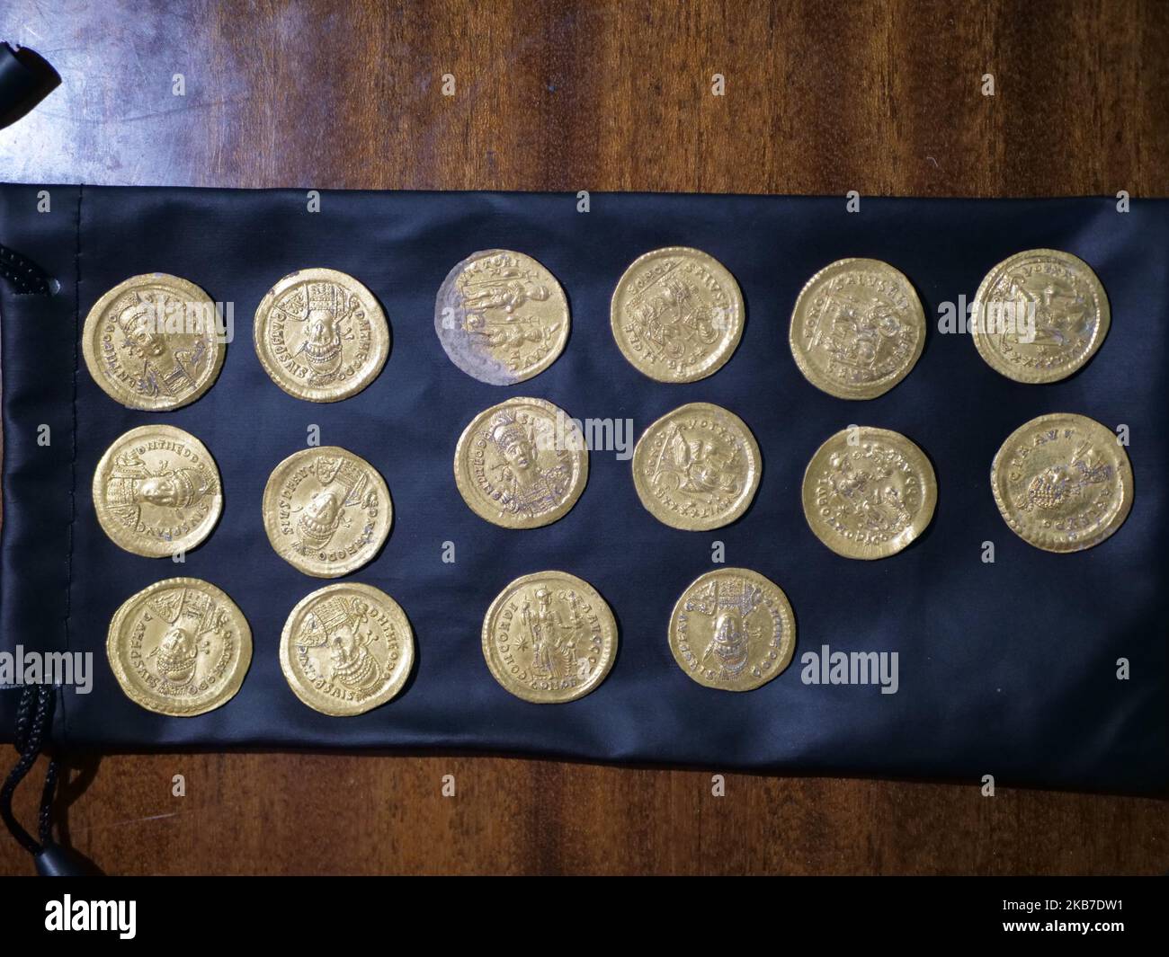 The archaeologist Hristo Kuzov shows golden coins, discovered during ...