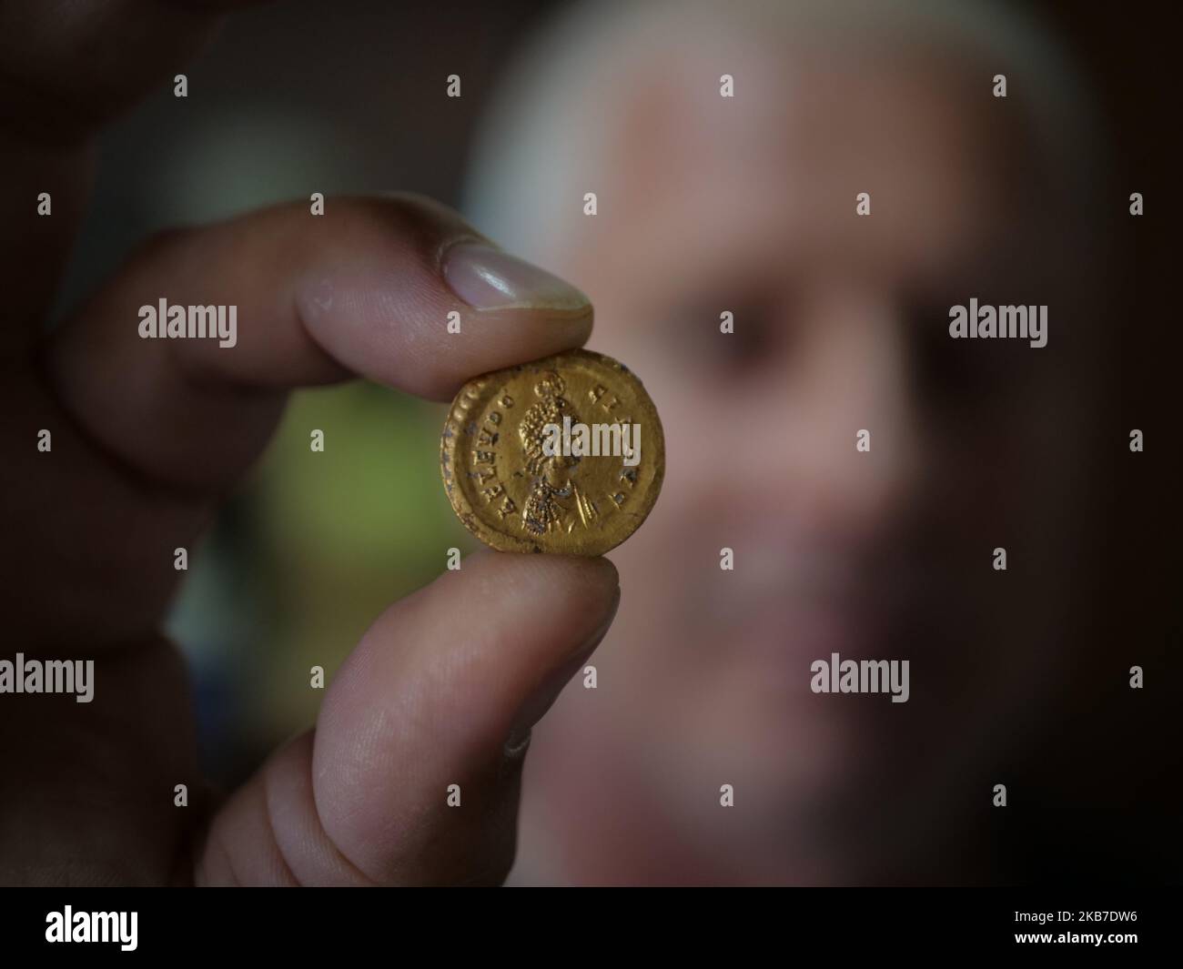 The archaeologist Hristo Kuzov shows golden coins, discovered during ...