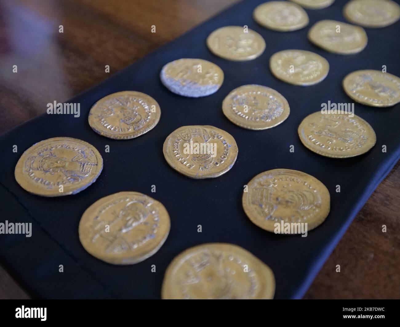 The archaeologist Hristo Kuzov shows golden coins, discovered during ...