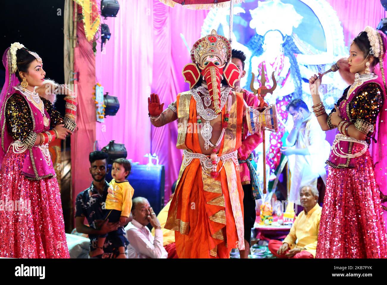 An Indian artist dressed as Hindu god Lord Ganesha performs during ...