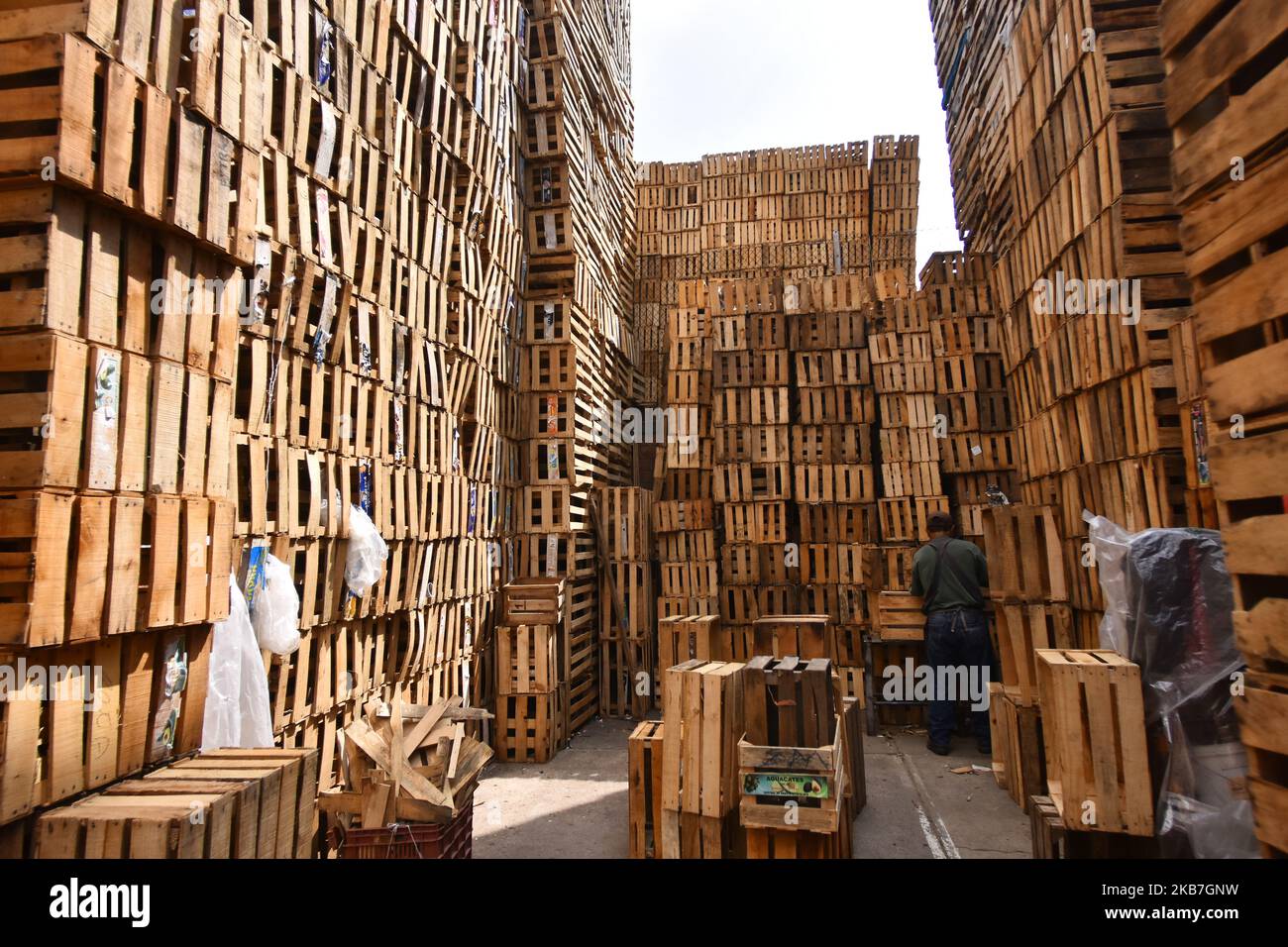A man is seen working accommodating boxes of fruit and vegetables in ...