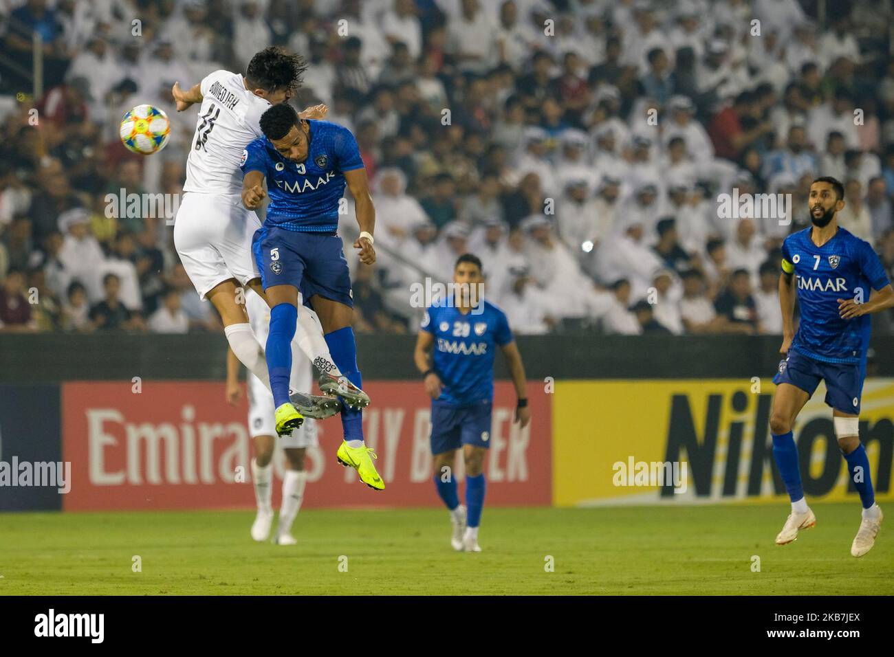 Ali Al-Bulaihi and Baghdad Bounedjah up for a header during the first ...