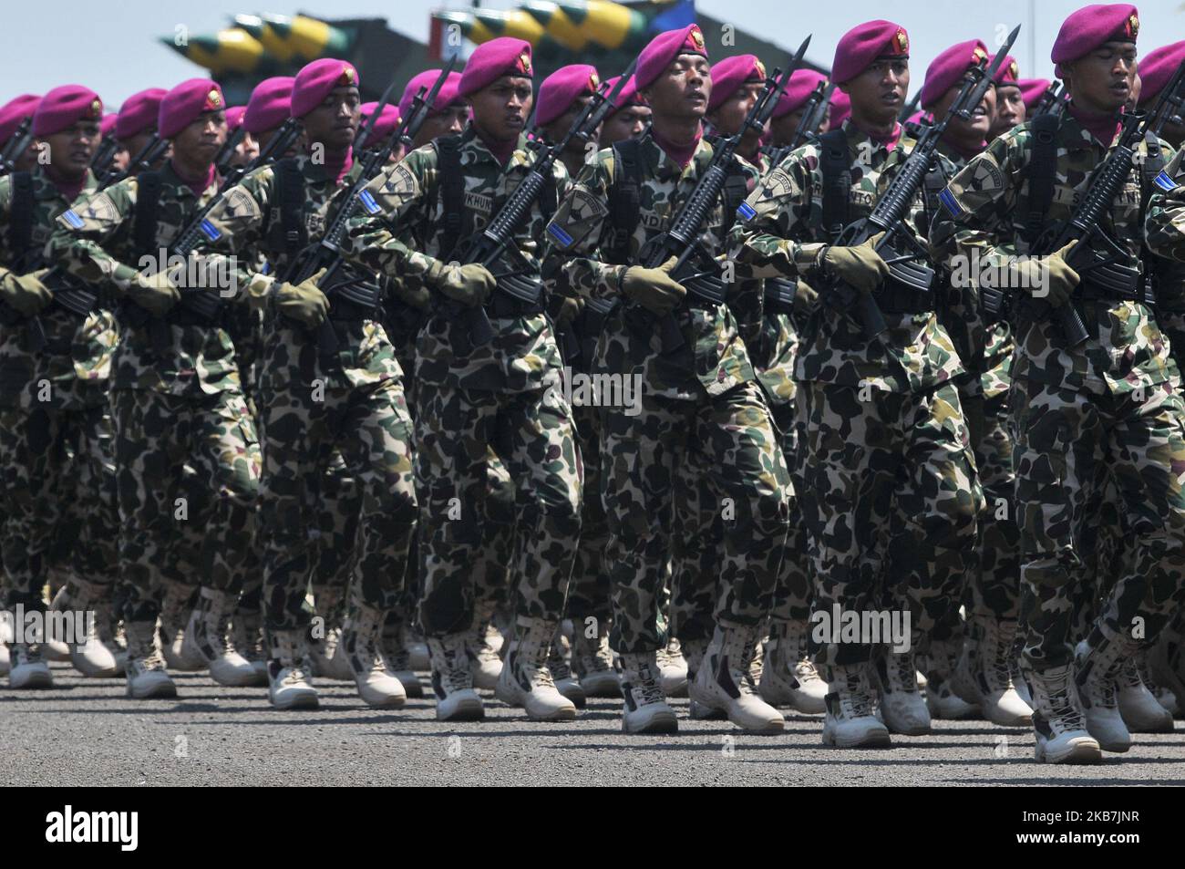 Indonesian National Armed Forces (TNI) soldiers mounted combat vehicles ...