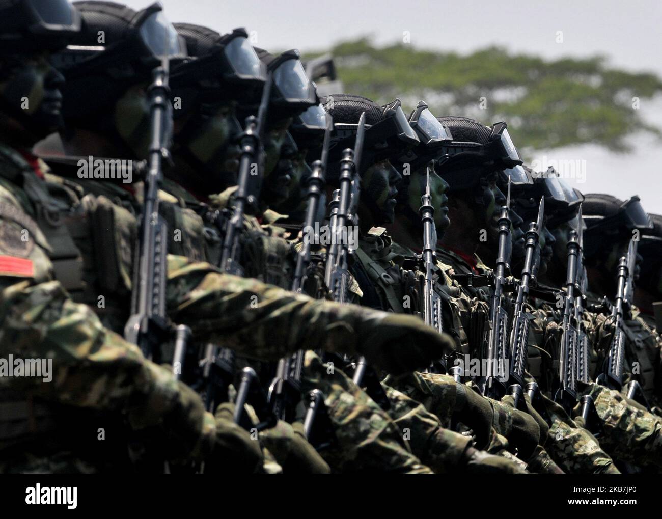 Indonesian National Armed Forces (TNI) soldiers mounted combat vehicles ...