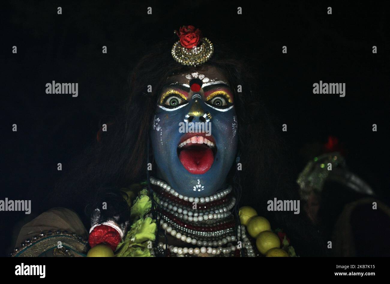 An Indian artist , dressed as Hindu Goddess 'Kali' performs during a ...