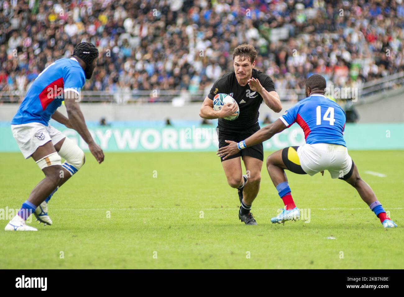 George Bridge of New Zealand is held by Lesley Klim of Namibia during ...