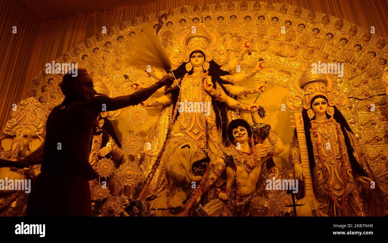 An Indian priest performs the ritual ‘Sandhi Puja’ on the occasion of ...