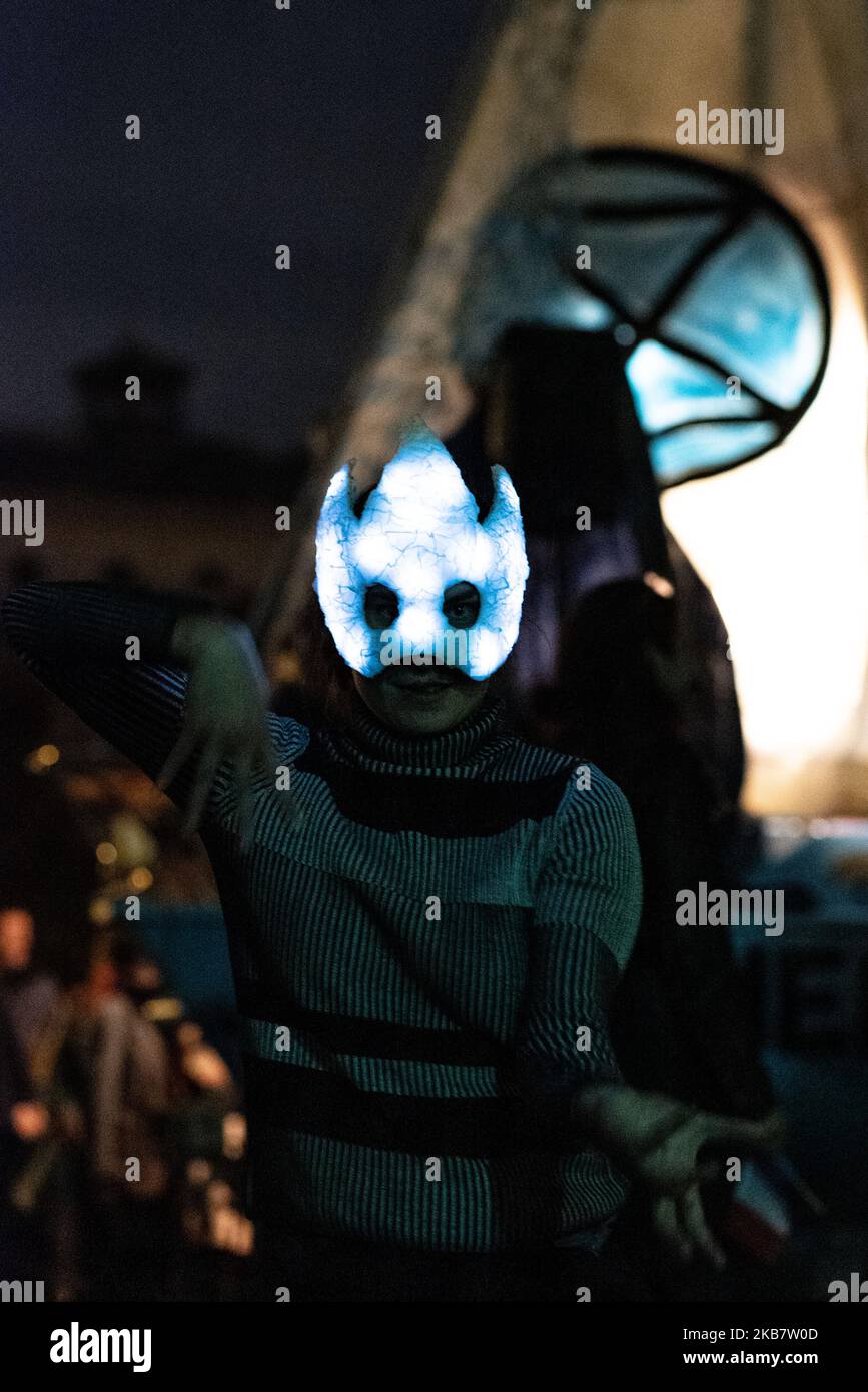 Portrait of an environmental activist wearing a luminous mask made of ...