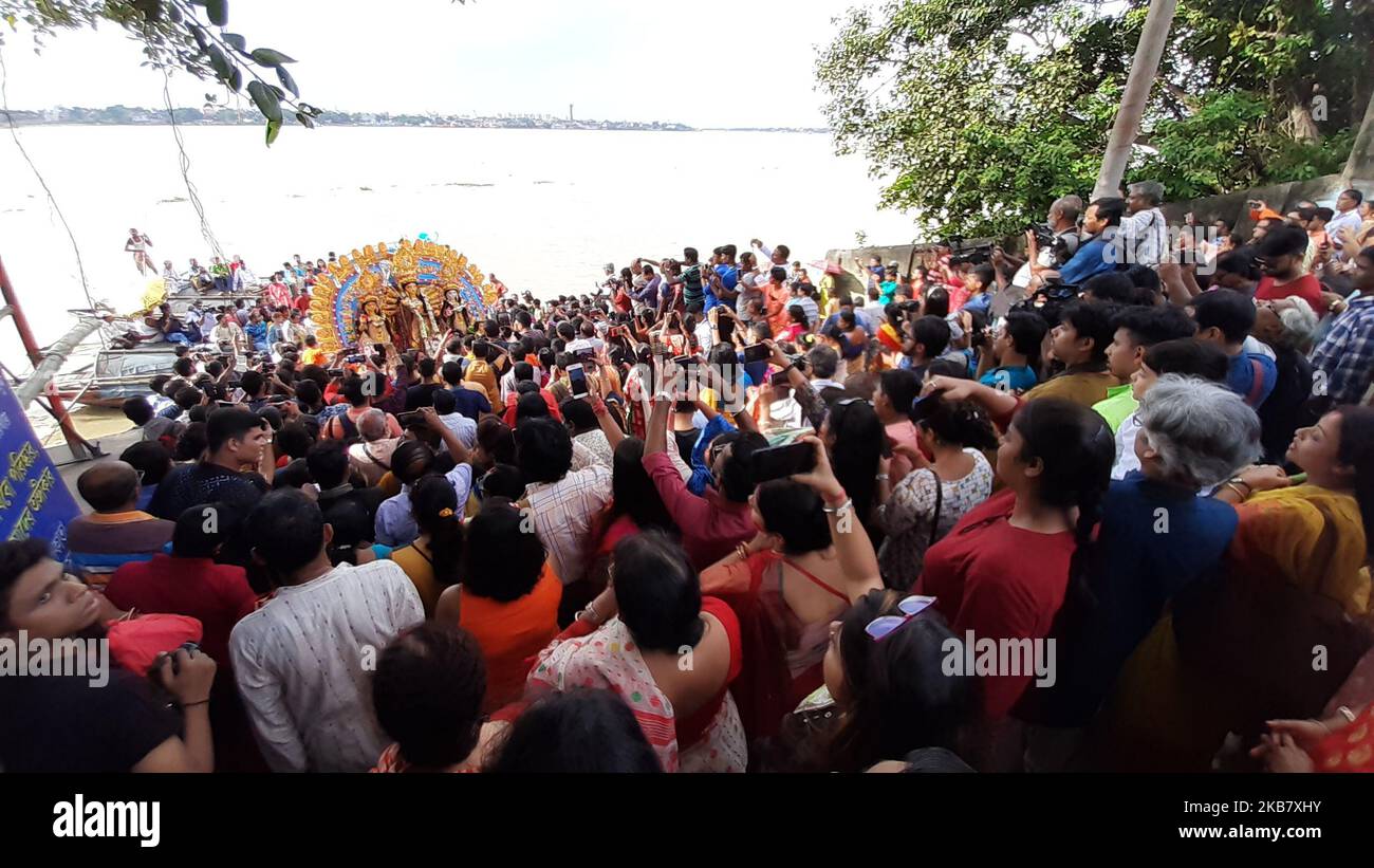 Hindu goddess Durga into the Ganges river during the immersion ceremony ...