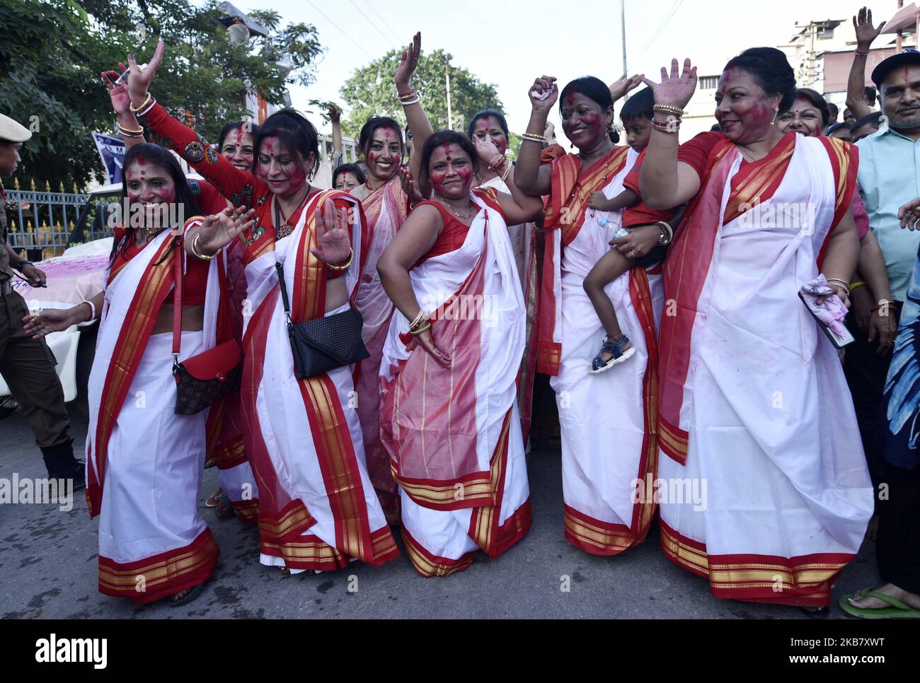 Devotees dance as Hindus immerse an idol of the goddess Durga in the ...