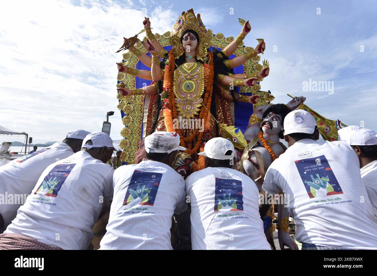 Municipal workers push an idol of Hindu goddess Durga into the ...