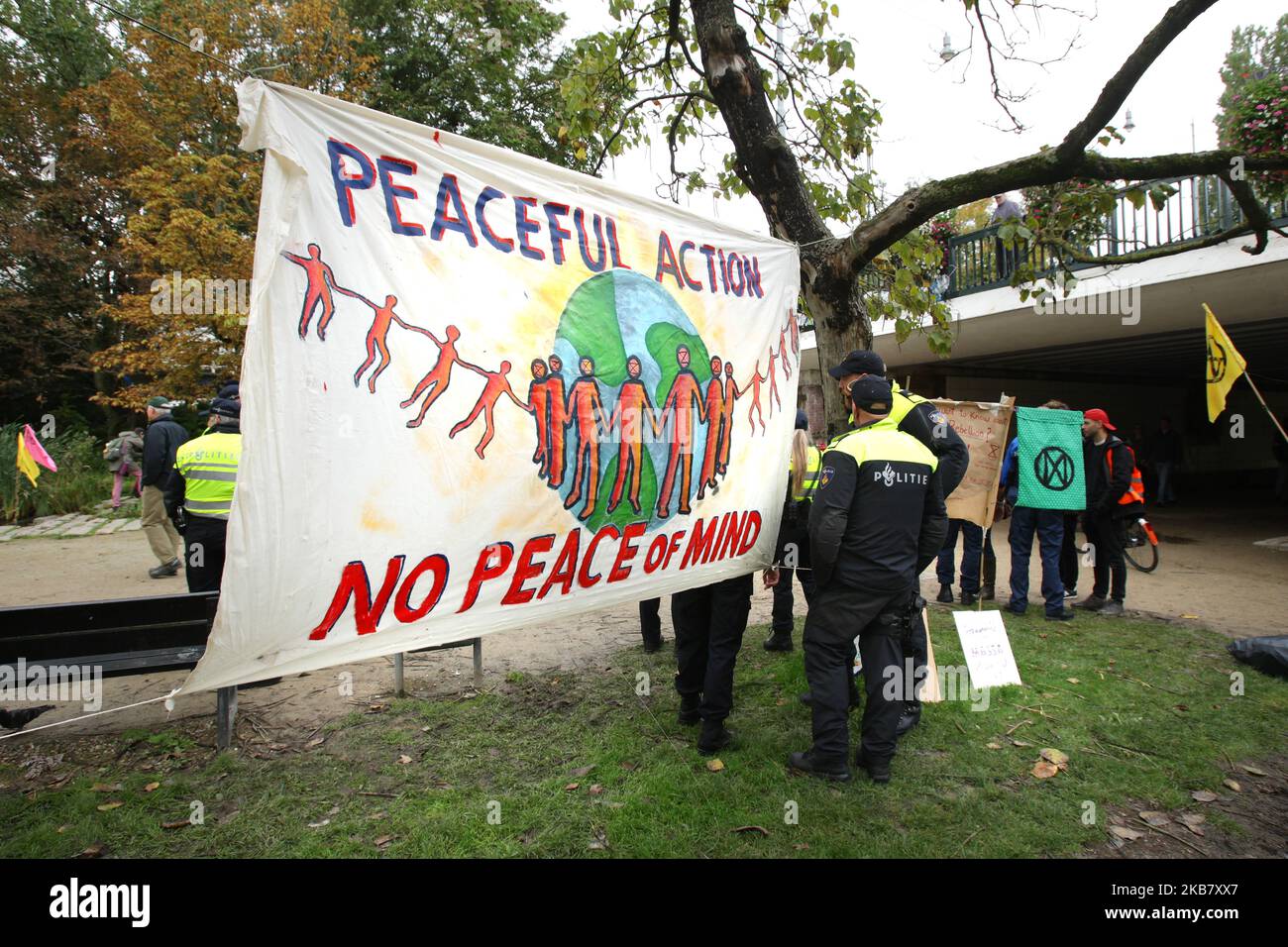 Dutch anti riot police officers watch as Extinction Rebellion Climate ...