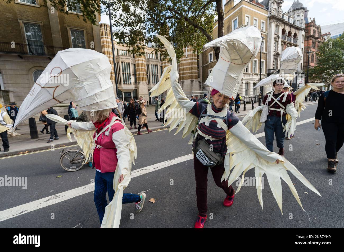Environmental activists from Extinction Rebellion wearing bird costumes ...