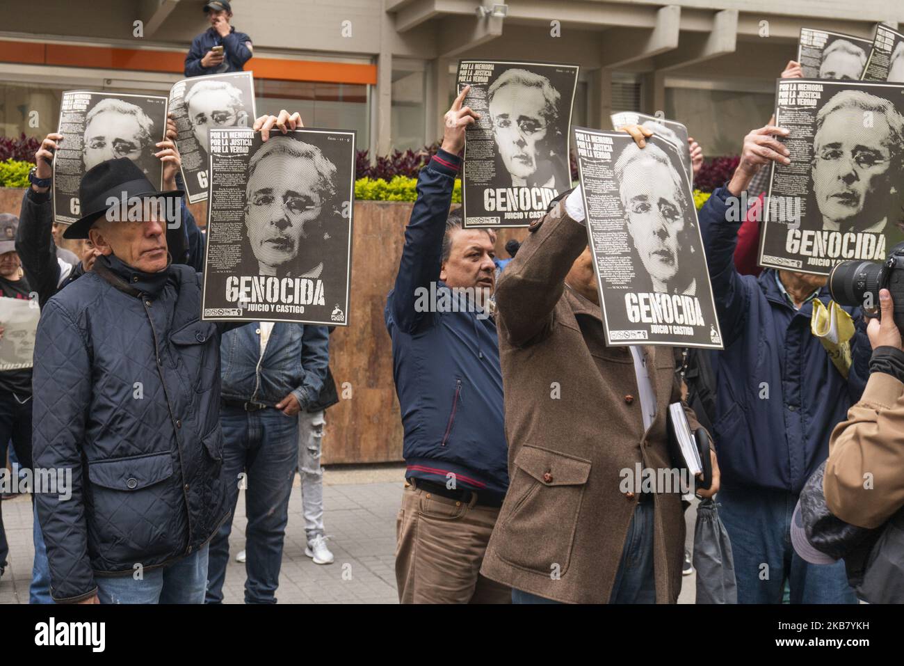 People opponents to former president Alvaro Uribe hold posters against ...