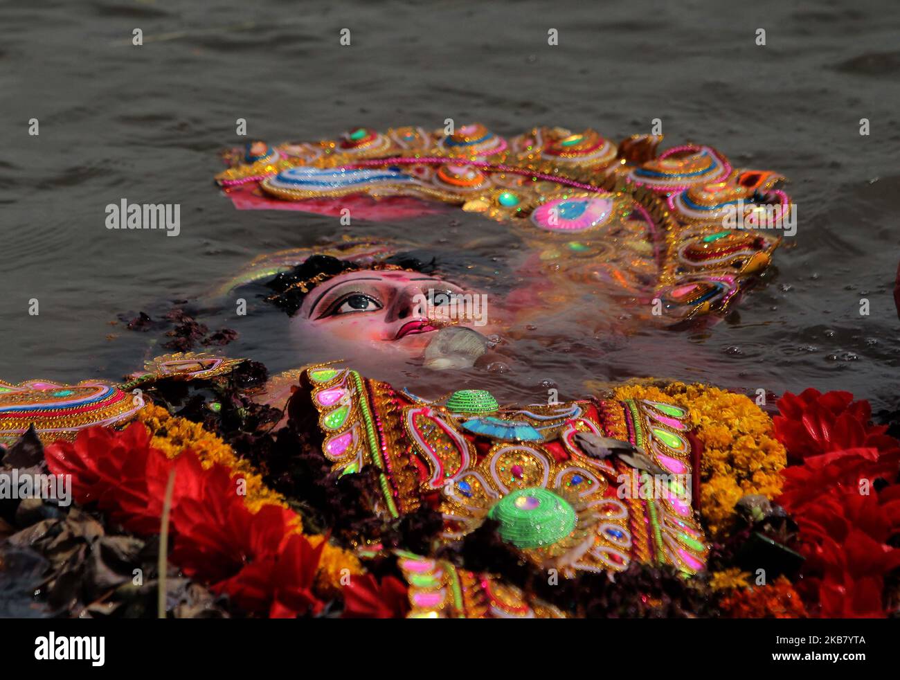 Devotees are seen on the banks of river 'Kuakhai' as they immerse the ...