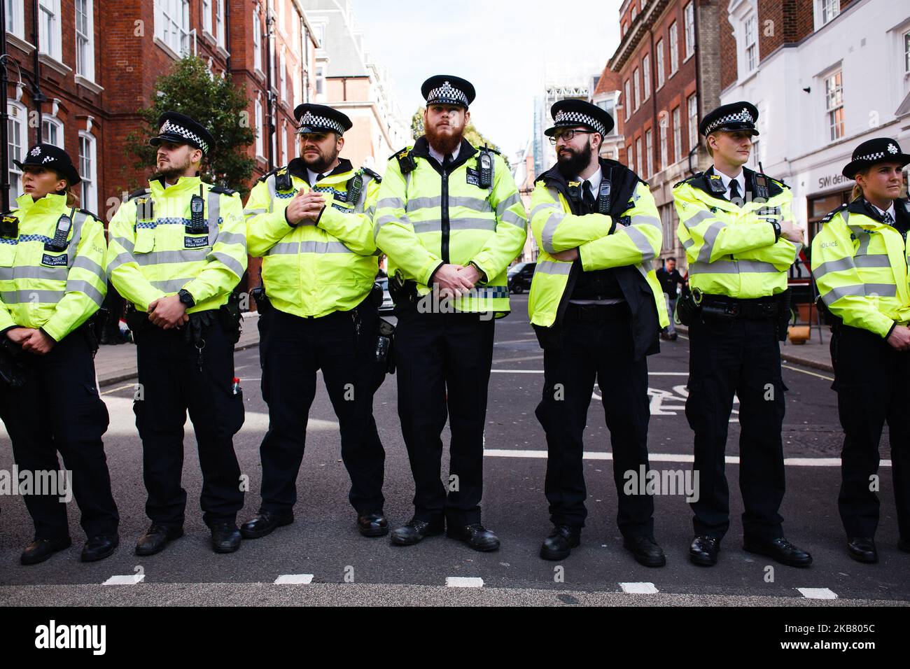 Police officers stretch across Great Peter Street, near the Home Office ...