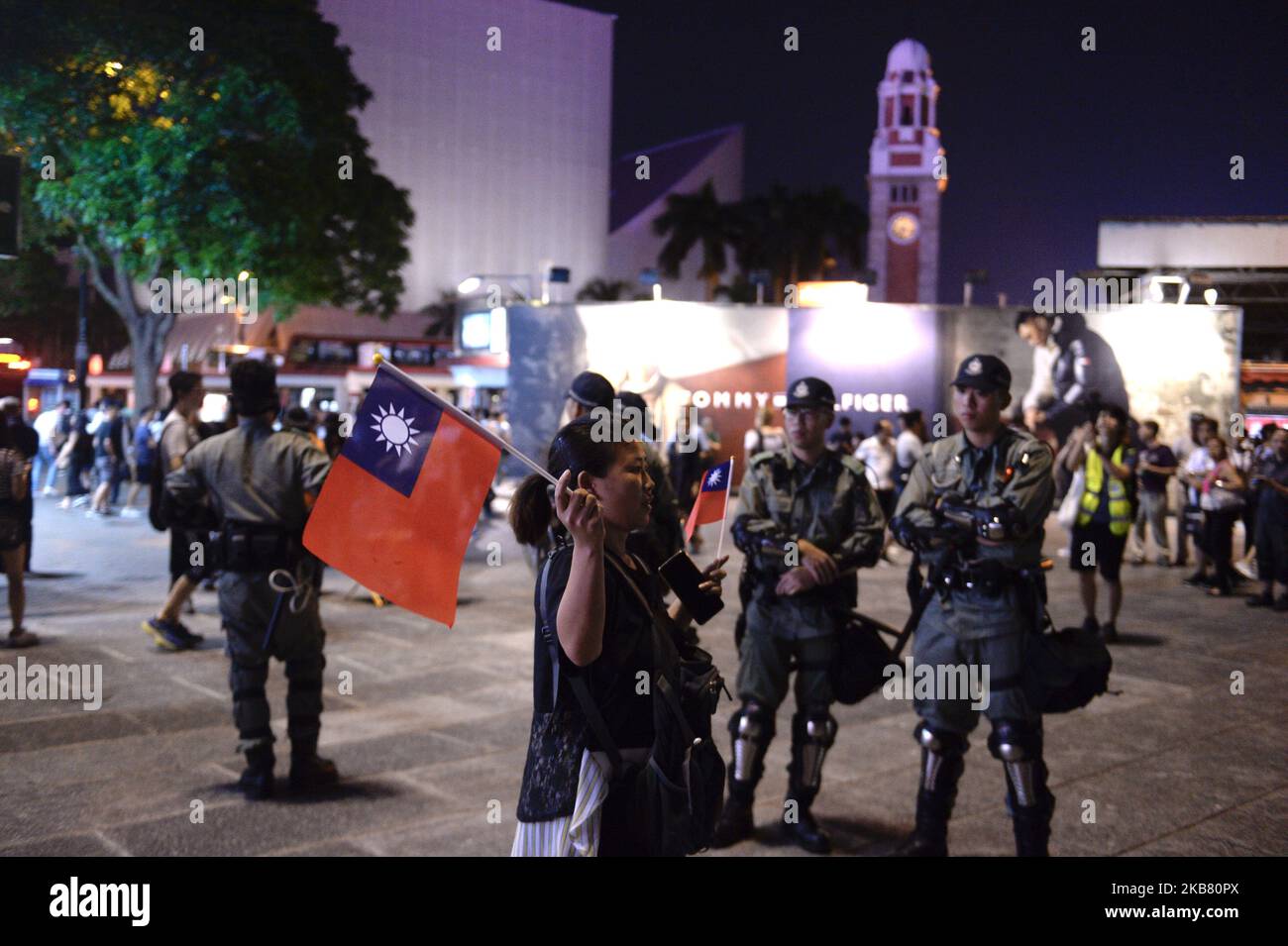 A women is seen holding up a Taiwan National Flag as she stands in ...