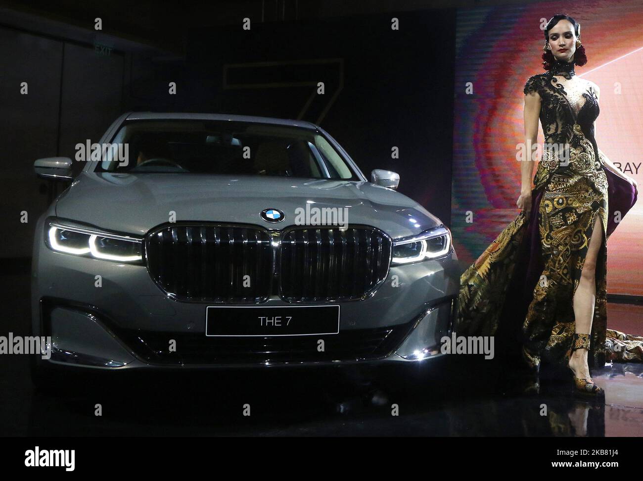 Models pose near The New BMW 730Li M Sport at the launch of the BMW 7 ...