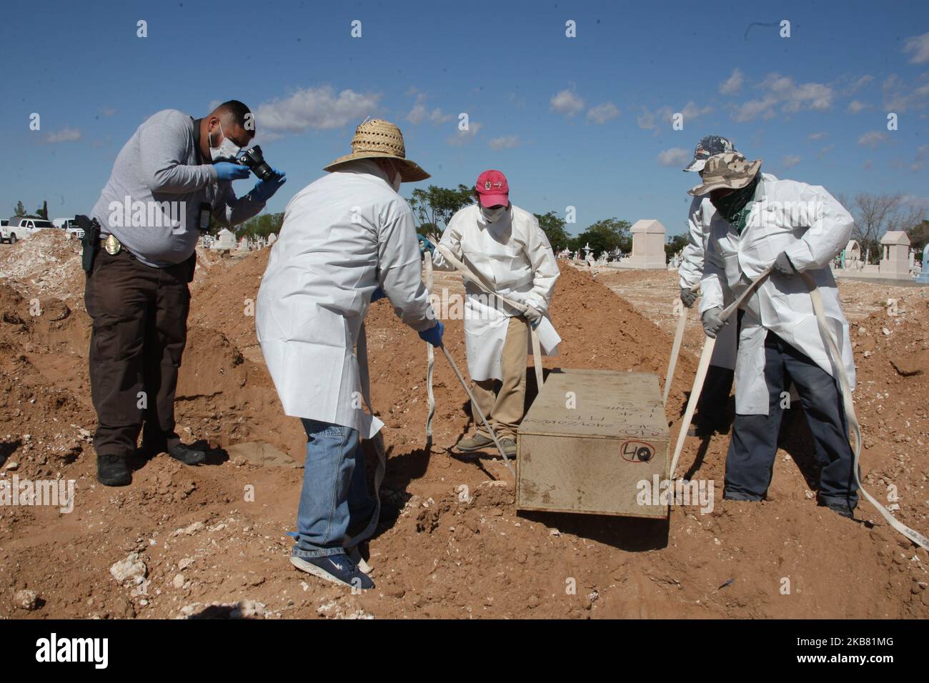 Judicial workers bury an unclaimed corpse in the San Rafael Municipal ...