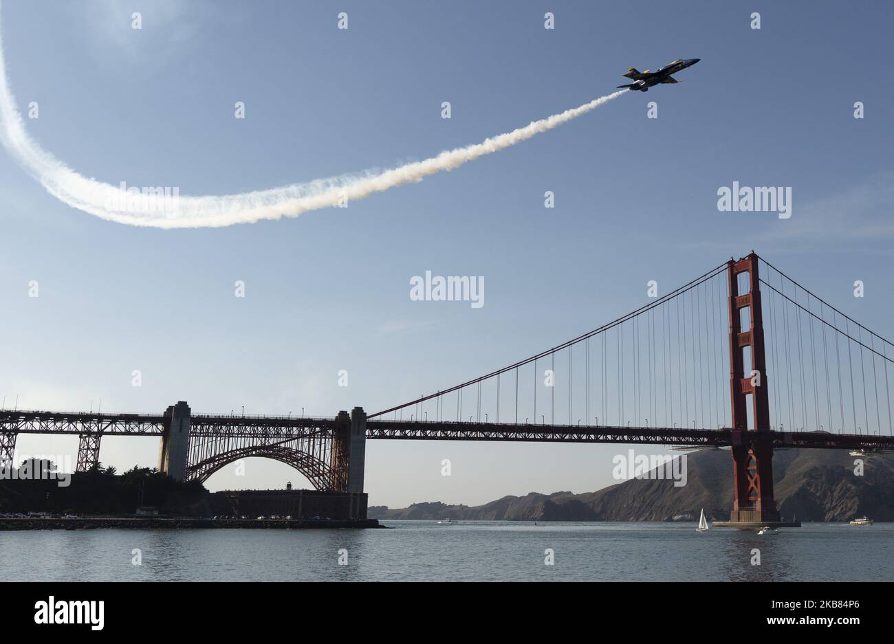 U. S. Navy Blue Angels F/A-18 jet flies over the Golden Gate Bridge ...
