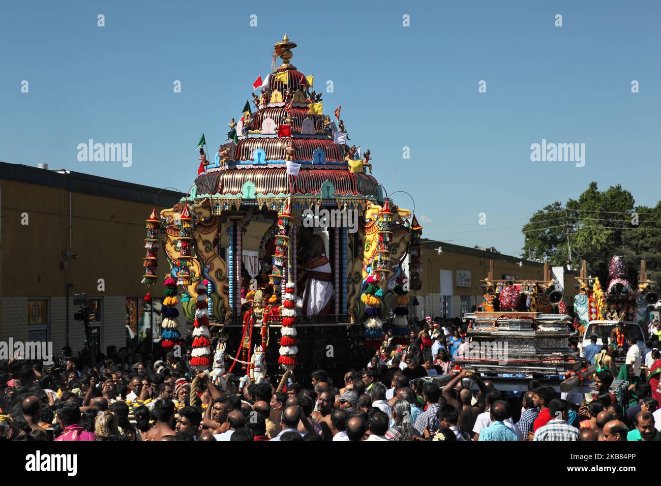 Tamil Hindu devotees take part in a religious procession as they escort ...