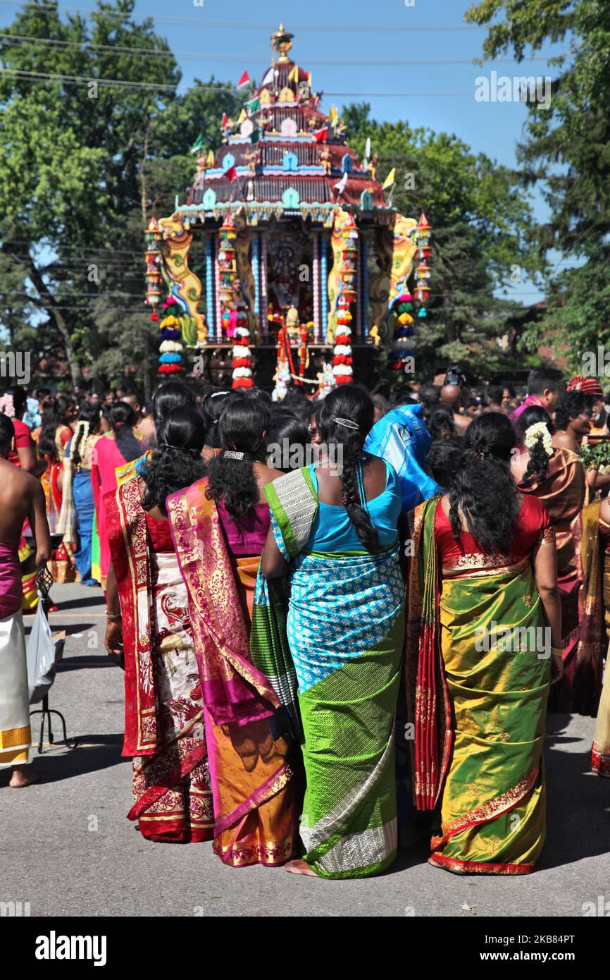 Tamil Hindu devotees take part in a religious procession as they escort ...