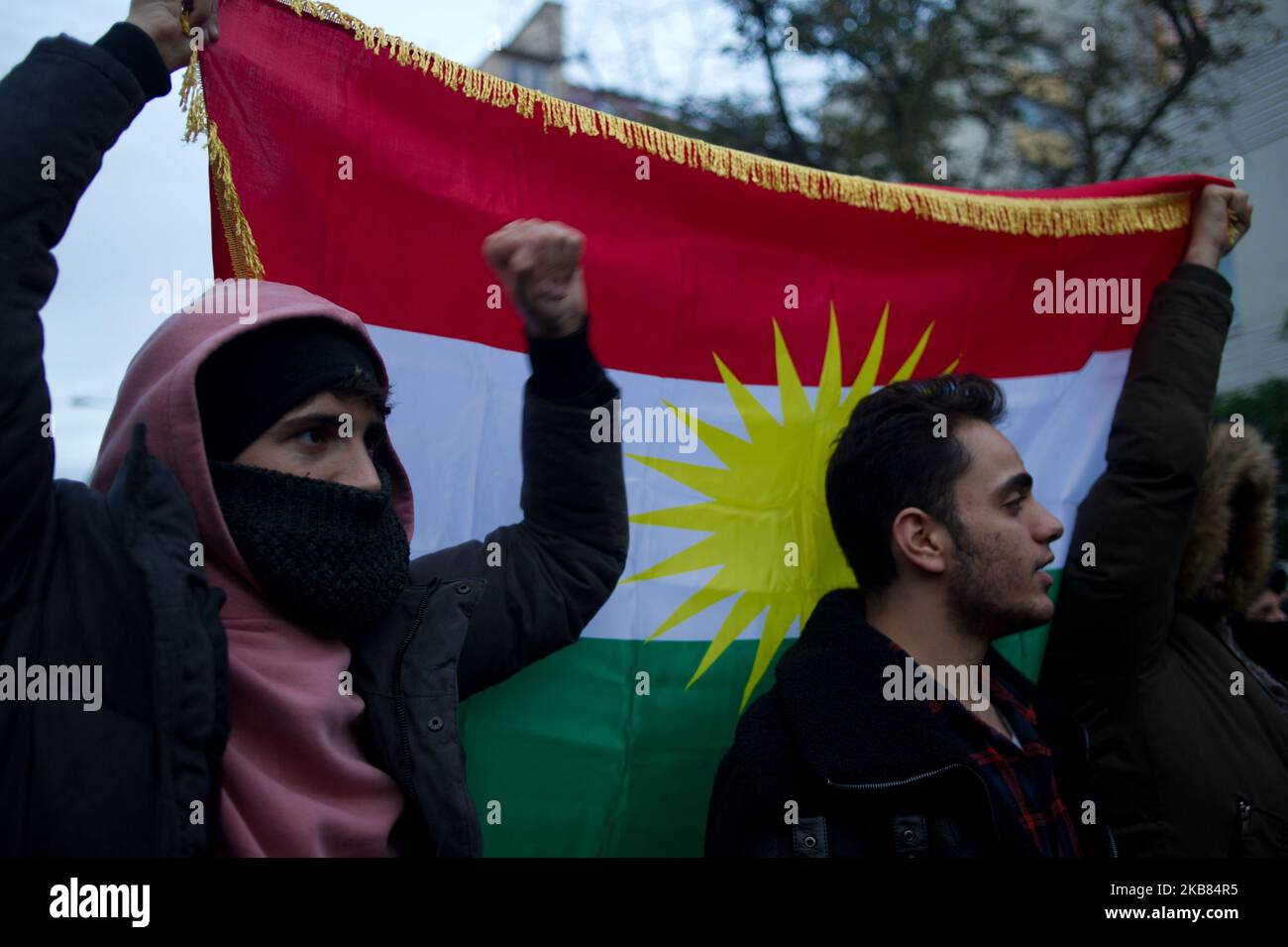 Demonstrators hold a Kurdistan flag during a protest against continuing ...