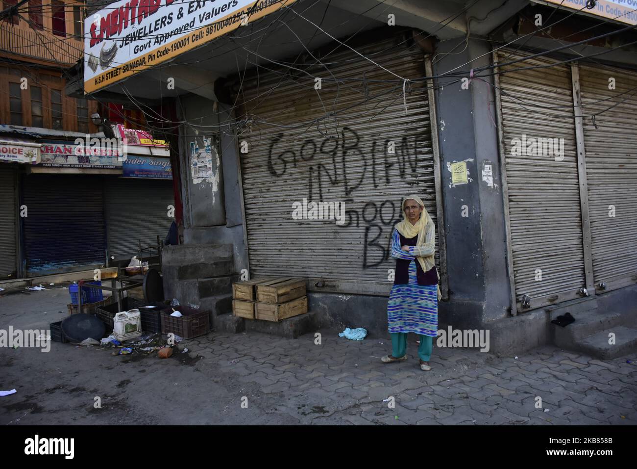 A women waits near closed shops after grenade attack took place in ...