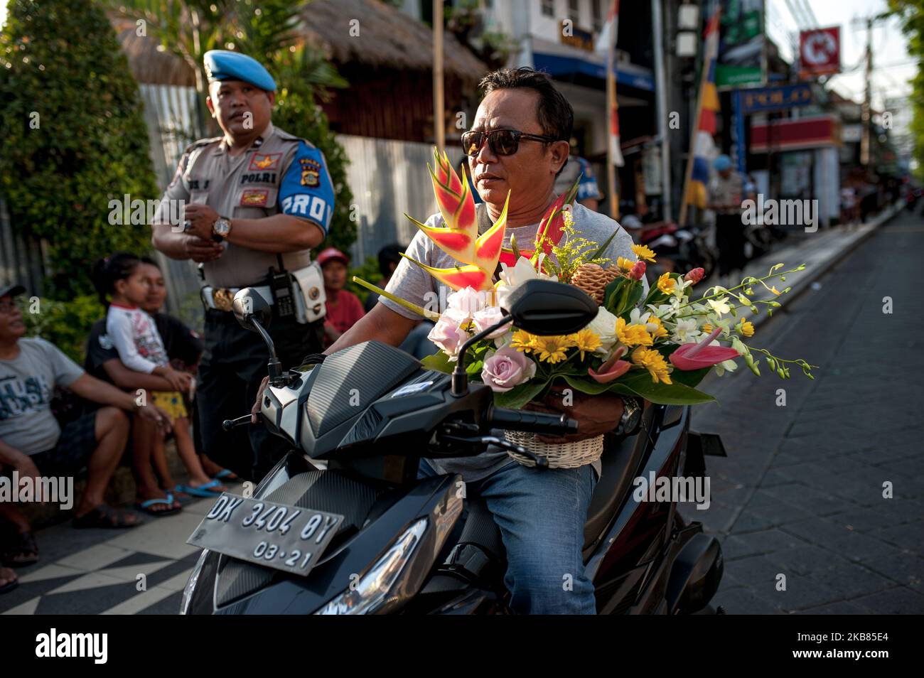 A man carrying wreaths to commemorate 17 years of attacks on the Bali ...