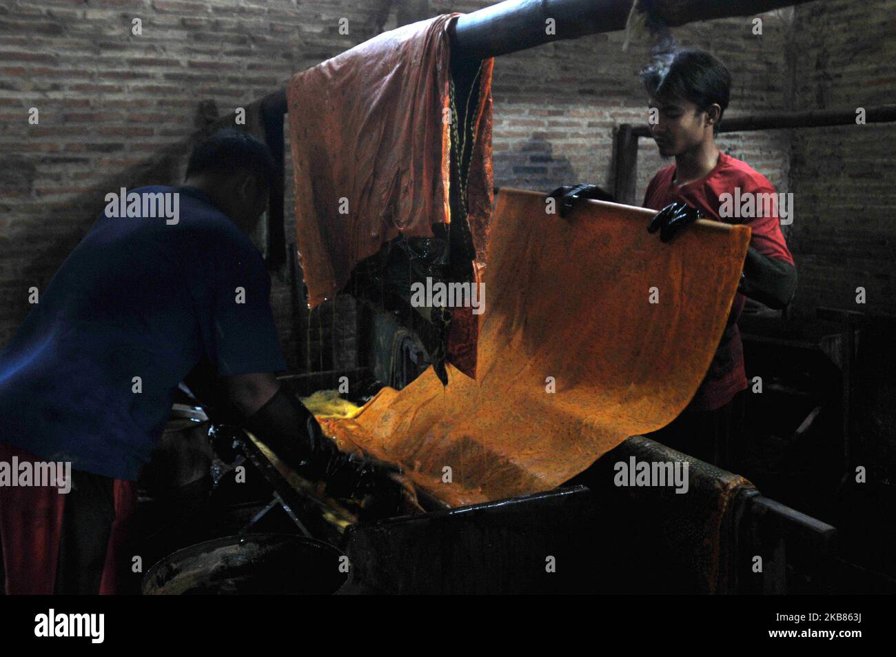 Workers are seen during the process of making, coloring and patterning ...