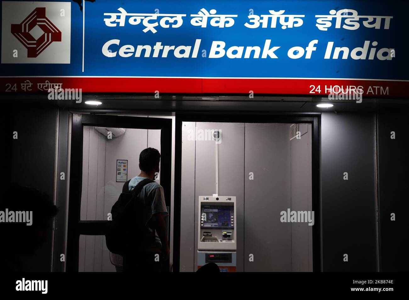 A man tries to enter an ATM of Central Bank of India in New Delhi India ...