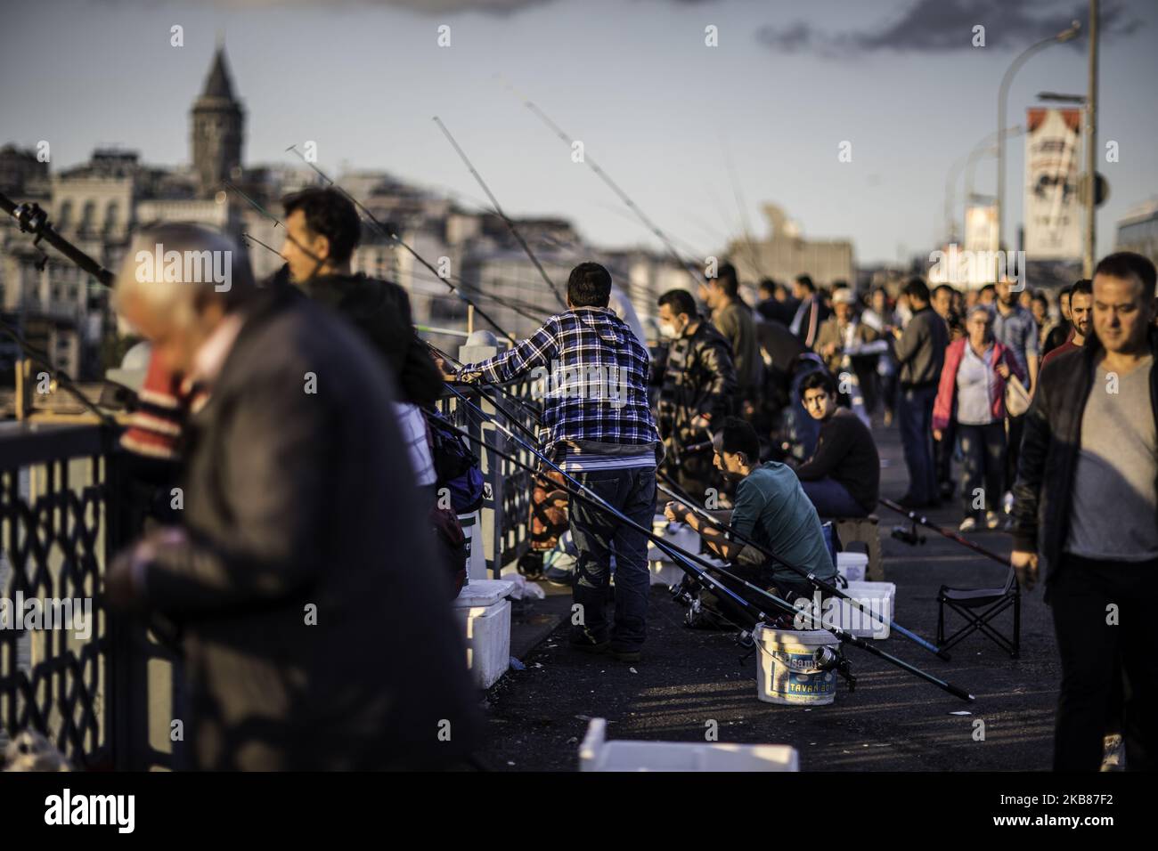 People fishing ont eh Galata bridge in Istanbul on 13 October 2019 ...