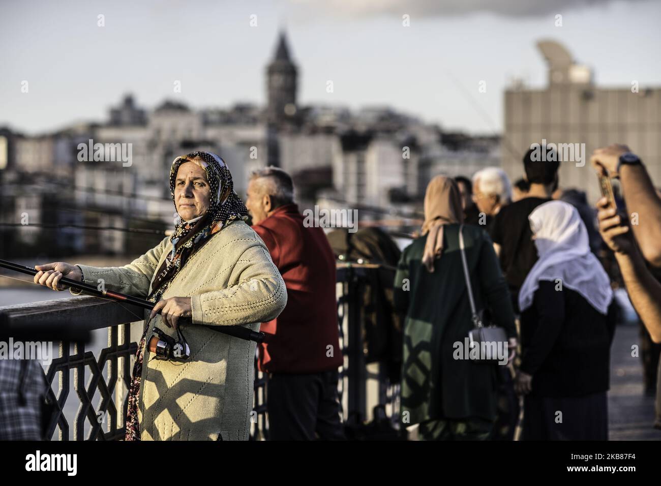 People fishing ont eh Galata bridge in Istanbul on 13 October 2019 ...