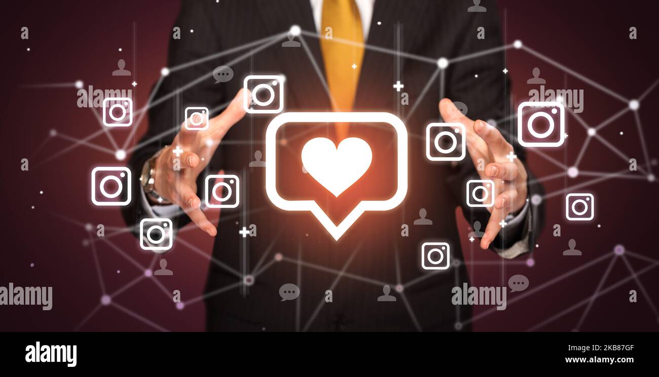 Hand holding social media icons Stock Photo - Alamy