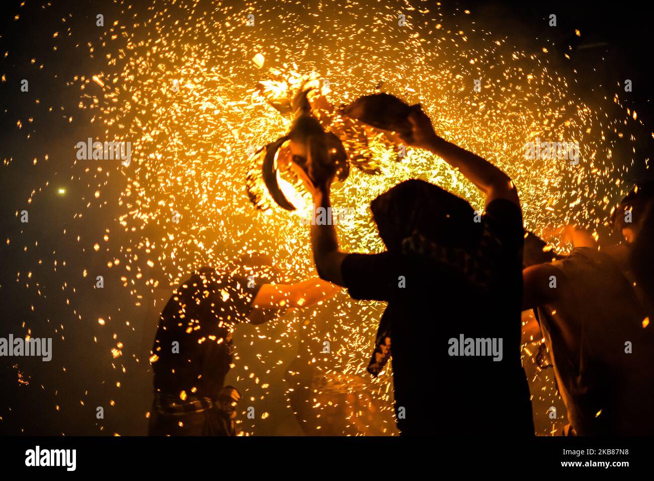 Dozens of Tuban village youths throwing coconut husks full of fire to ...