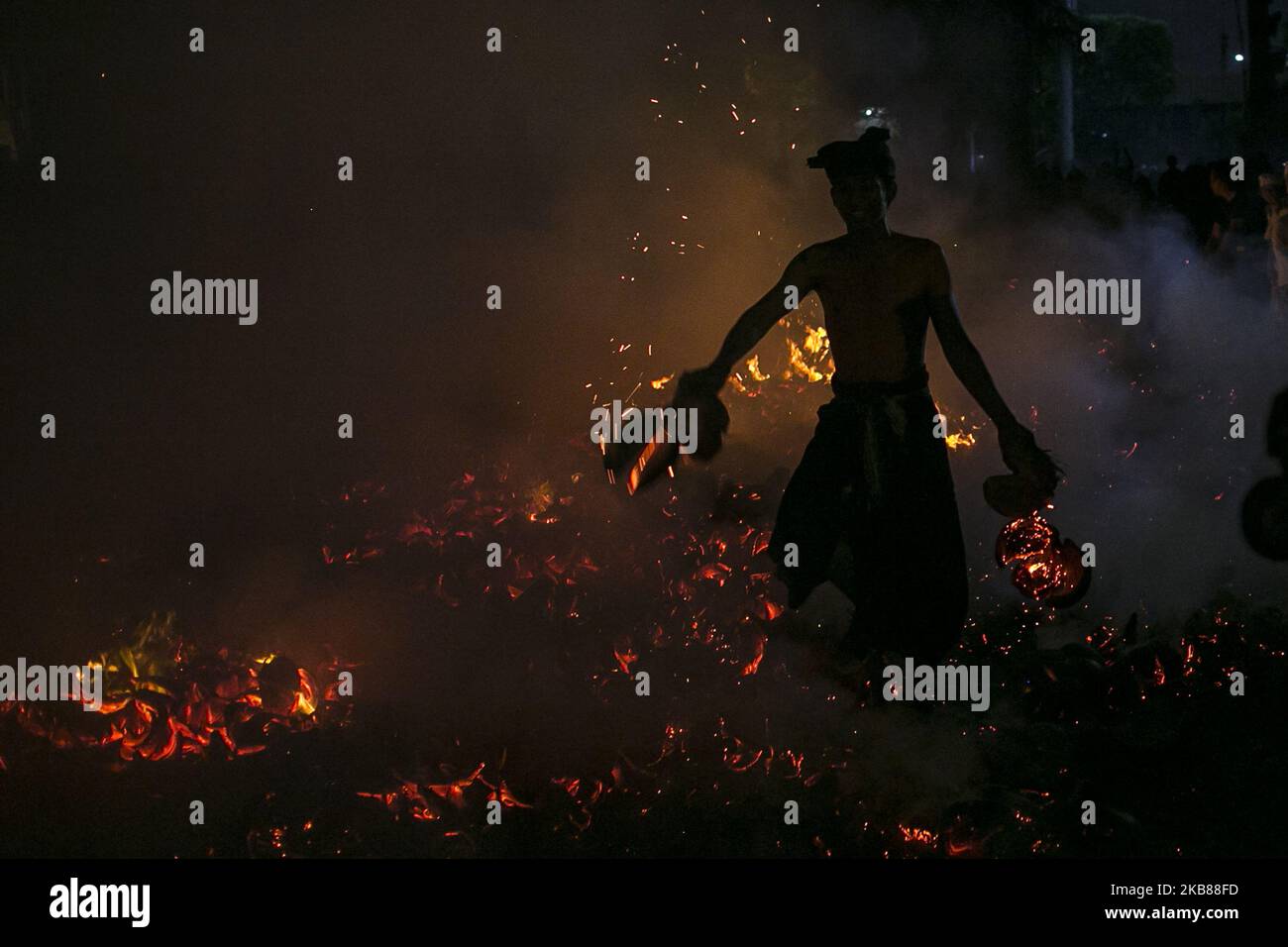 Balinese youngsters carries burnt dried coconut shells during the Siat ...