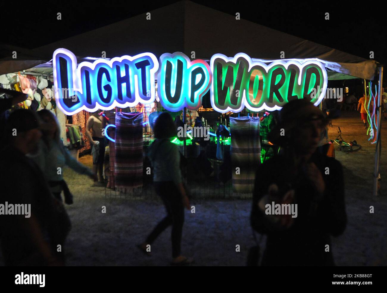 People walk past a vendor's lighting display at the 4th annual Suwannee ...