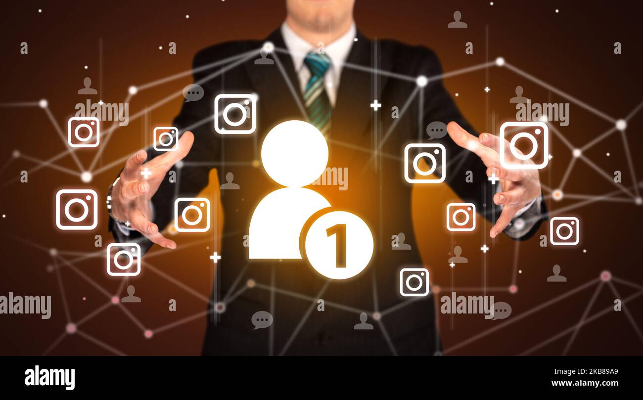 Hand holding social media icons Stock Photo - Alamy