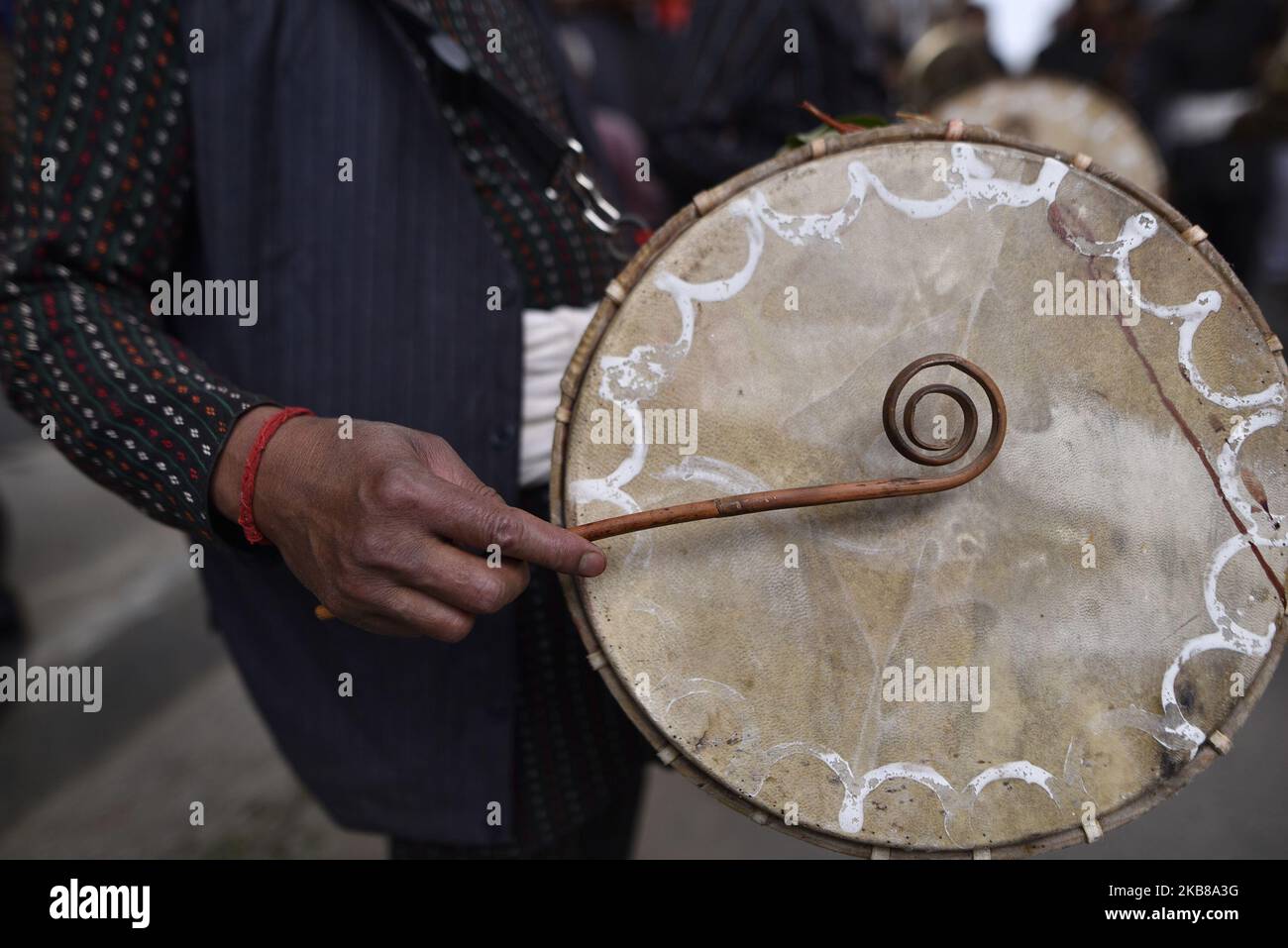 A Devotee playing traditional instrument as Locals carry and rotates ...