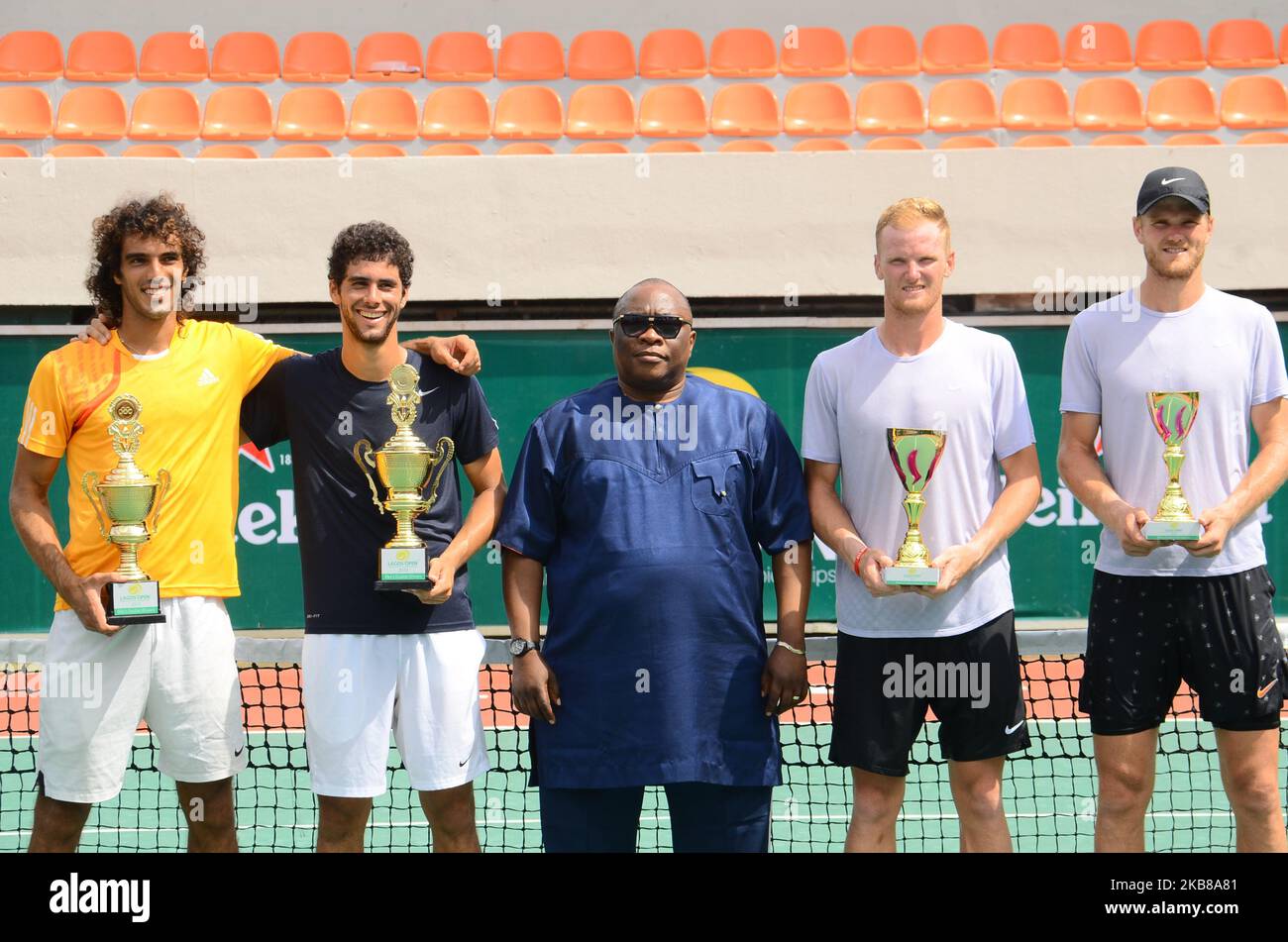 Tunisians Skander Monsouri (L) and Aziz Dougaz (2nd-L) pose with trophy ...