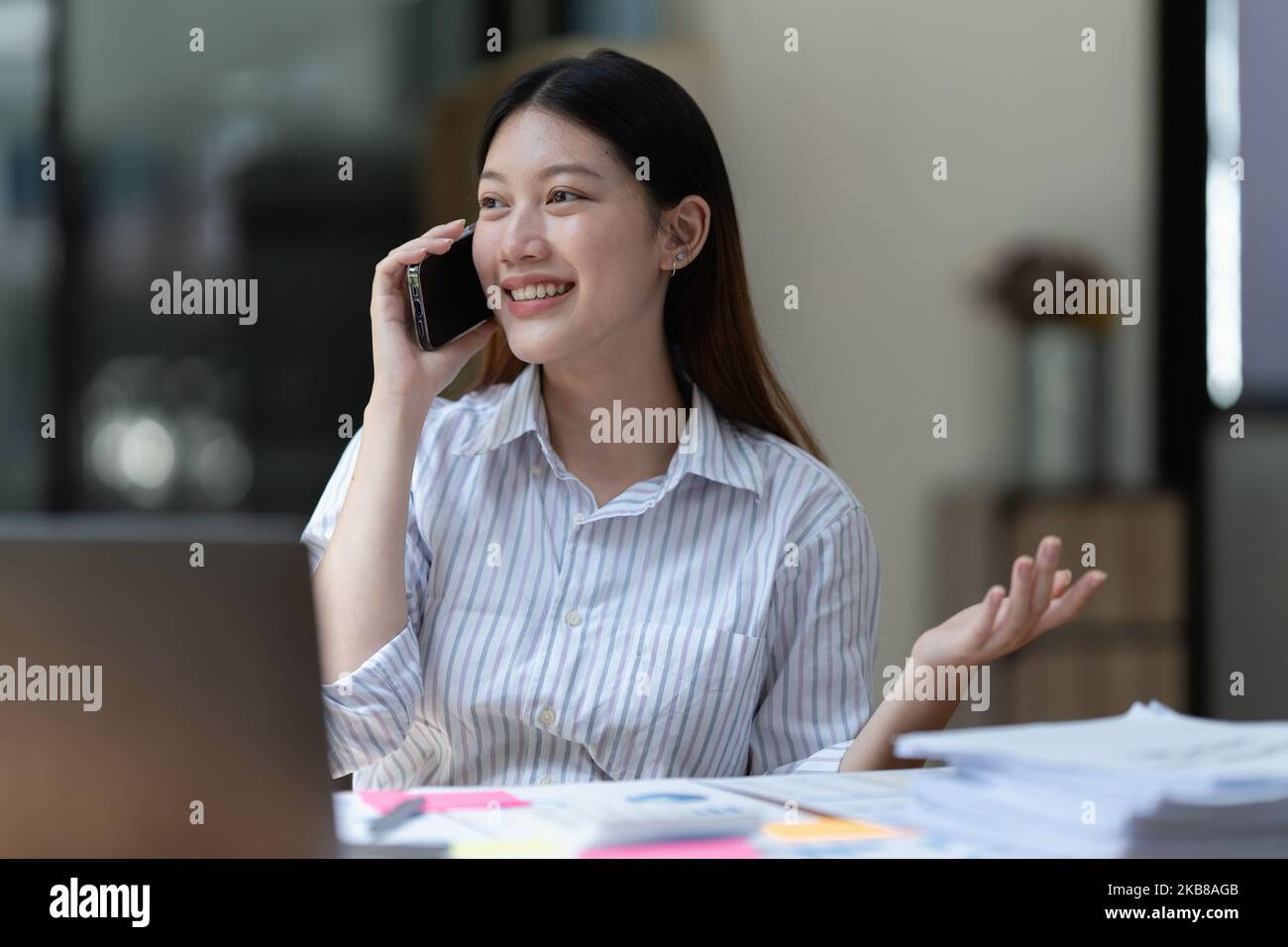 Happy Asian business woman talking with client on the cell phone Stock ...