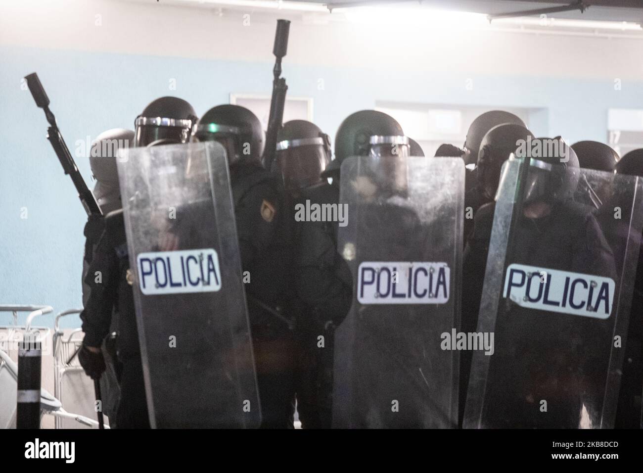 A spanish police riot with guns and shields during a protests in ...