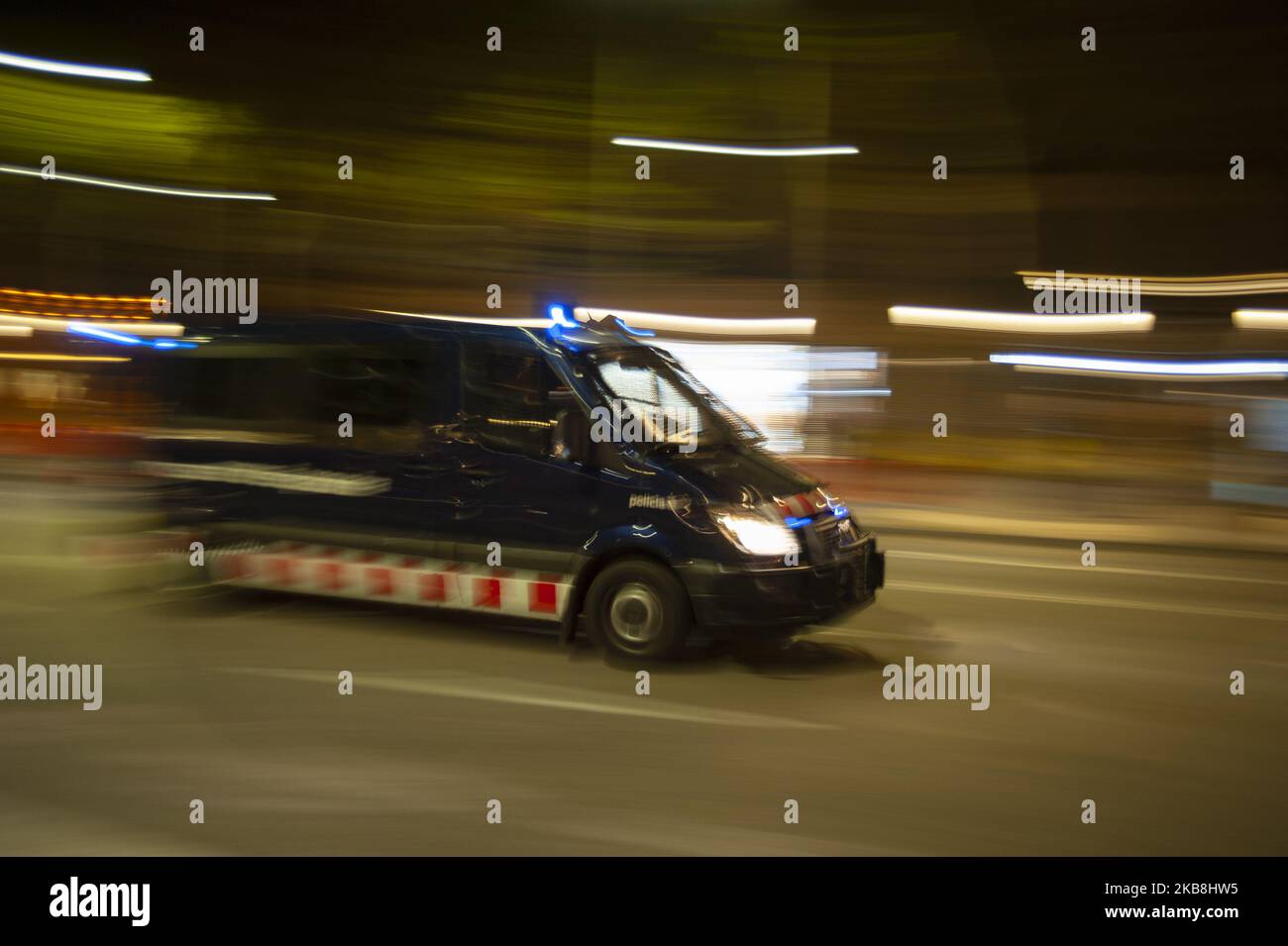 A riot police car is moving at high speed so that people can run in ...
